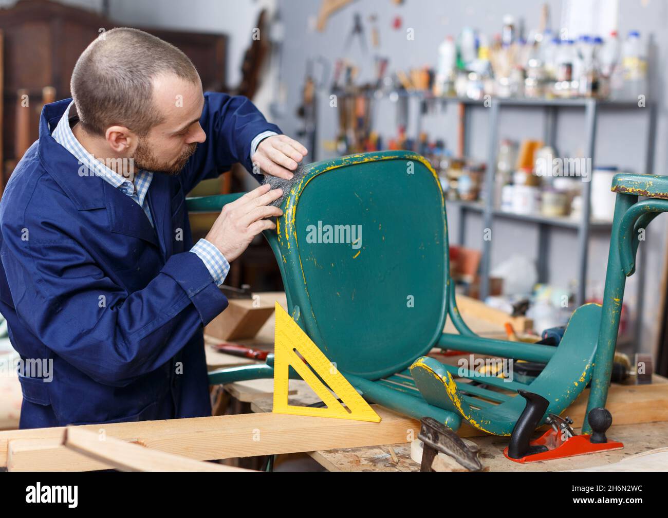 Furniture restorer renovation antique chair Stock Photo - Alamy