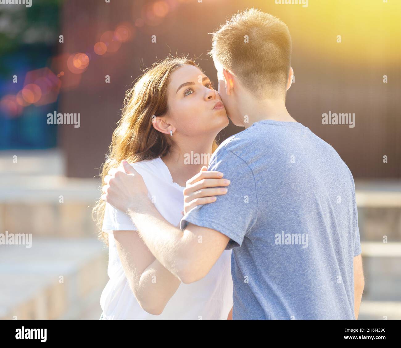 Two young people are kissing Stock Photo - Alamy
