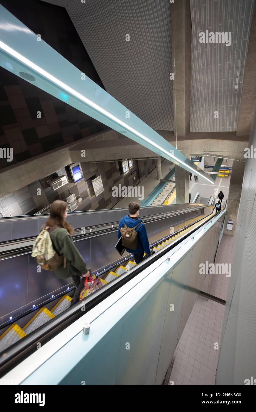 Passengers descend the escalator at the new Link Light Rail U District ...
