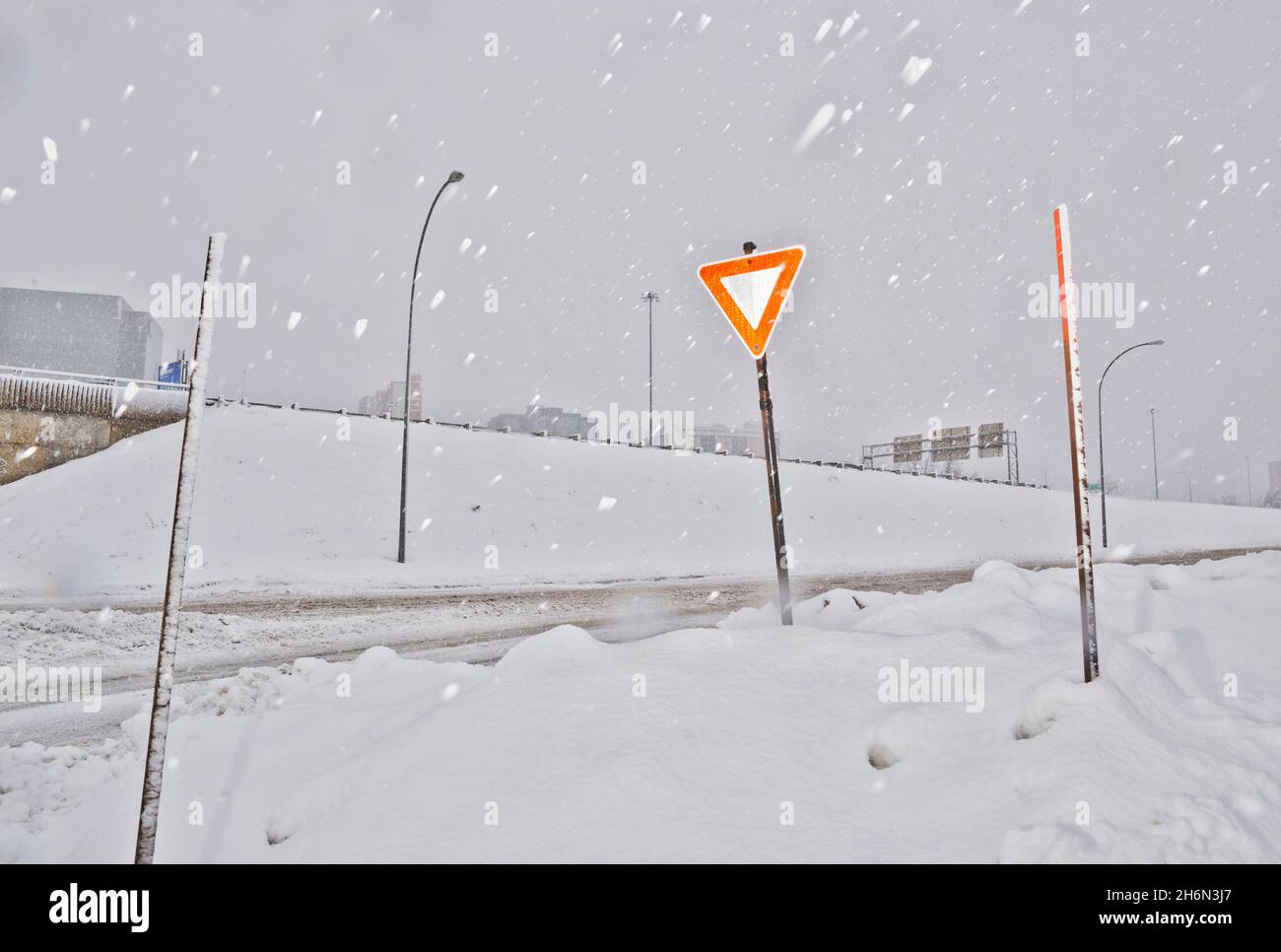 A traffic sign and poles during the winter in Longueuil, Quebec, Canada ...