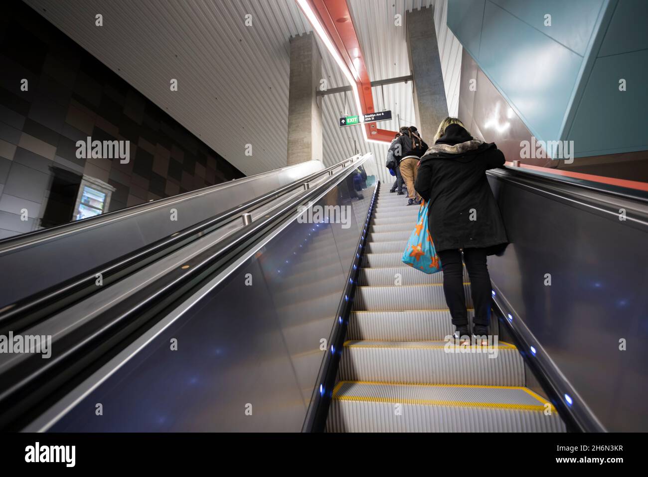 Passengers ascend the escalator at the new Link Light Rail U District ...