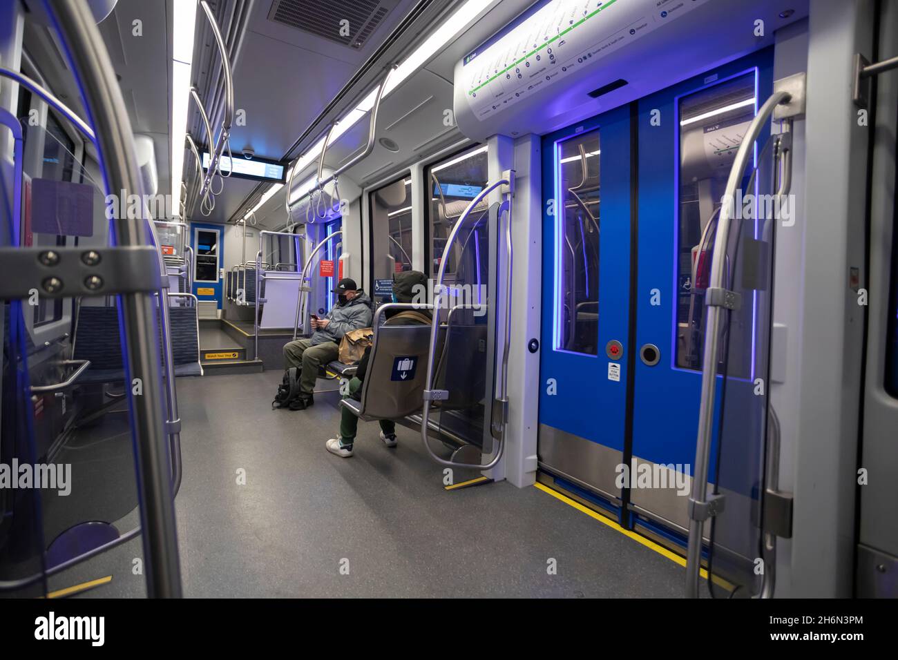 Passengers board a train at the new Link Light Rail Roosevelt Station ...