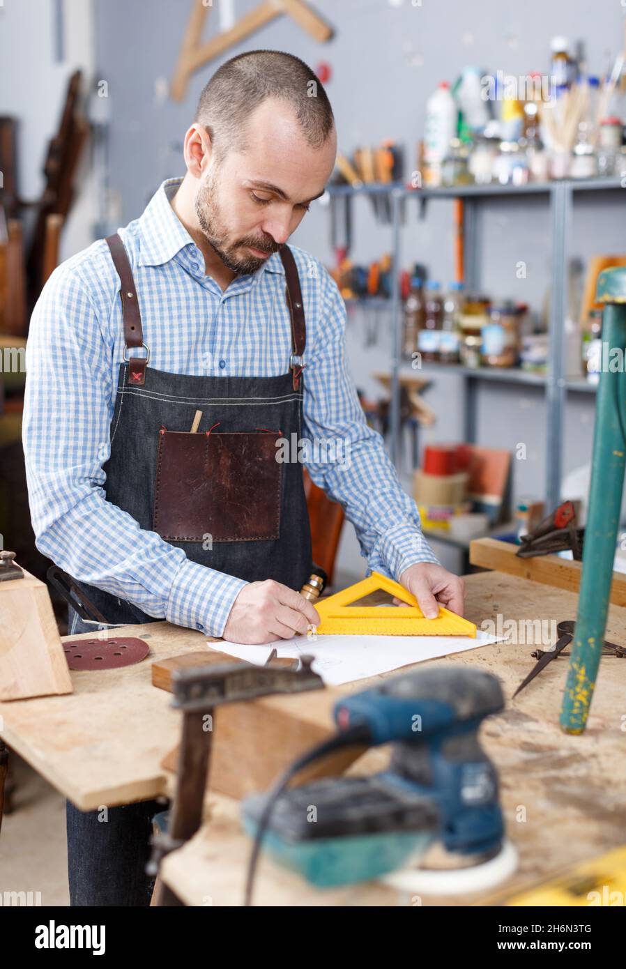 Carpenter measuring wooden plank Stock Photo - Alamy