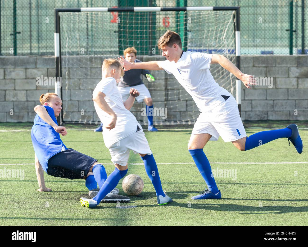 Young football player doing tackle Stock Photo - Alamy