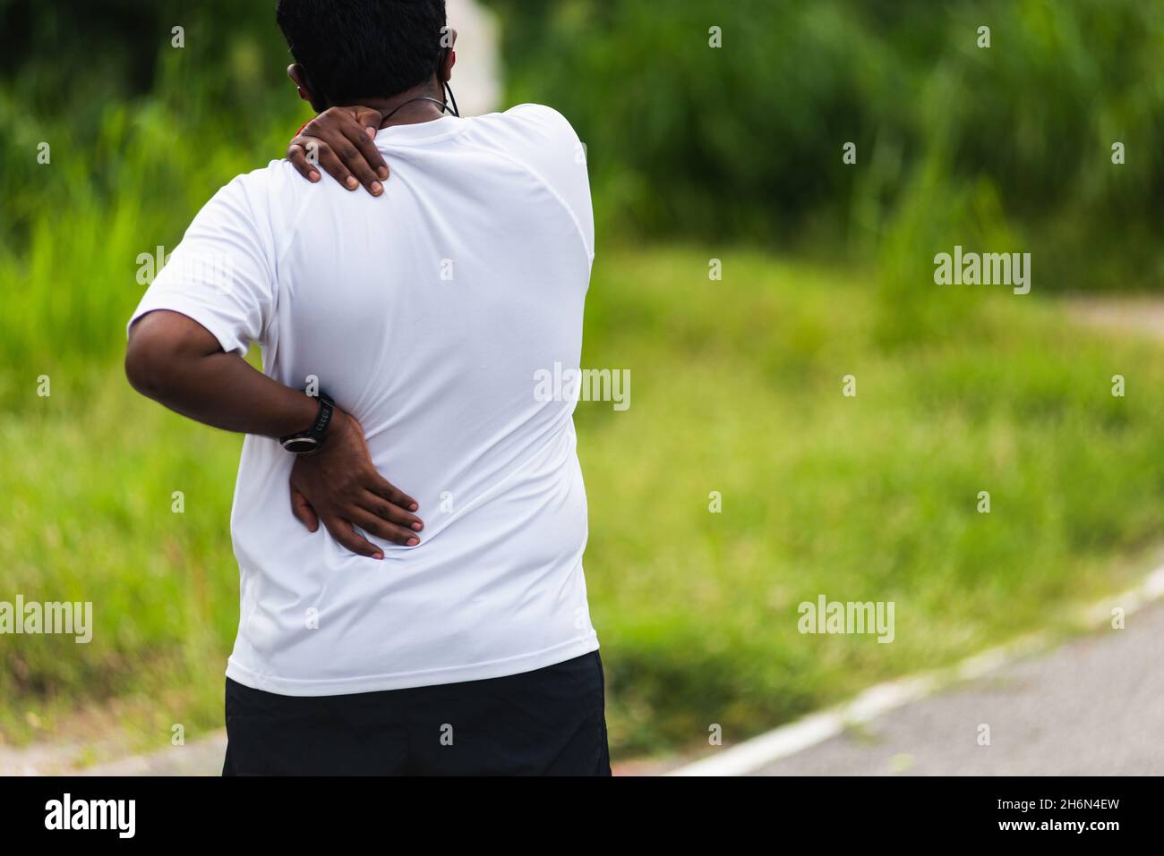 Close up Asian young sport runner black man wear watch hands joint hold ...