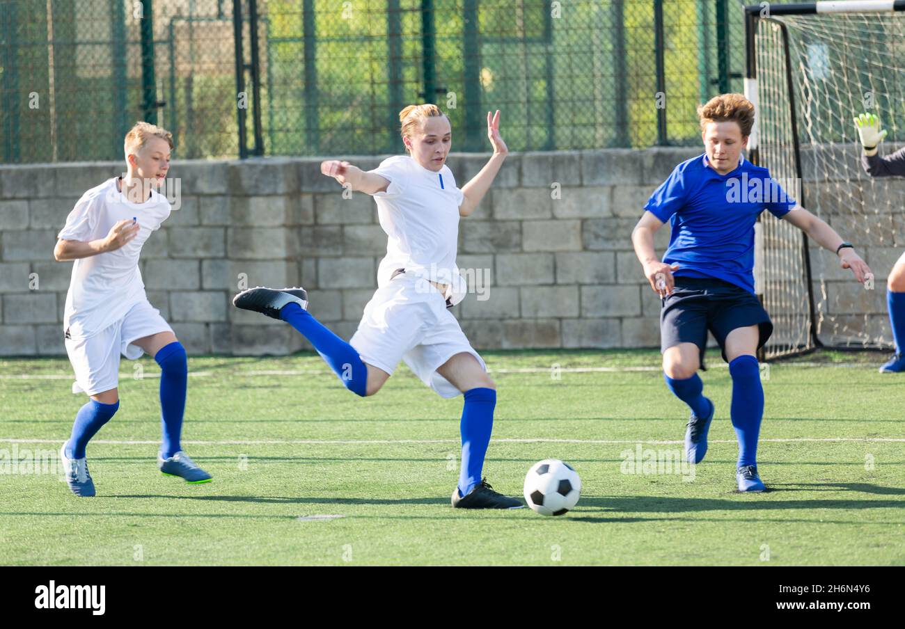 Teens playing soccer football match. Competition between two youth ...