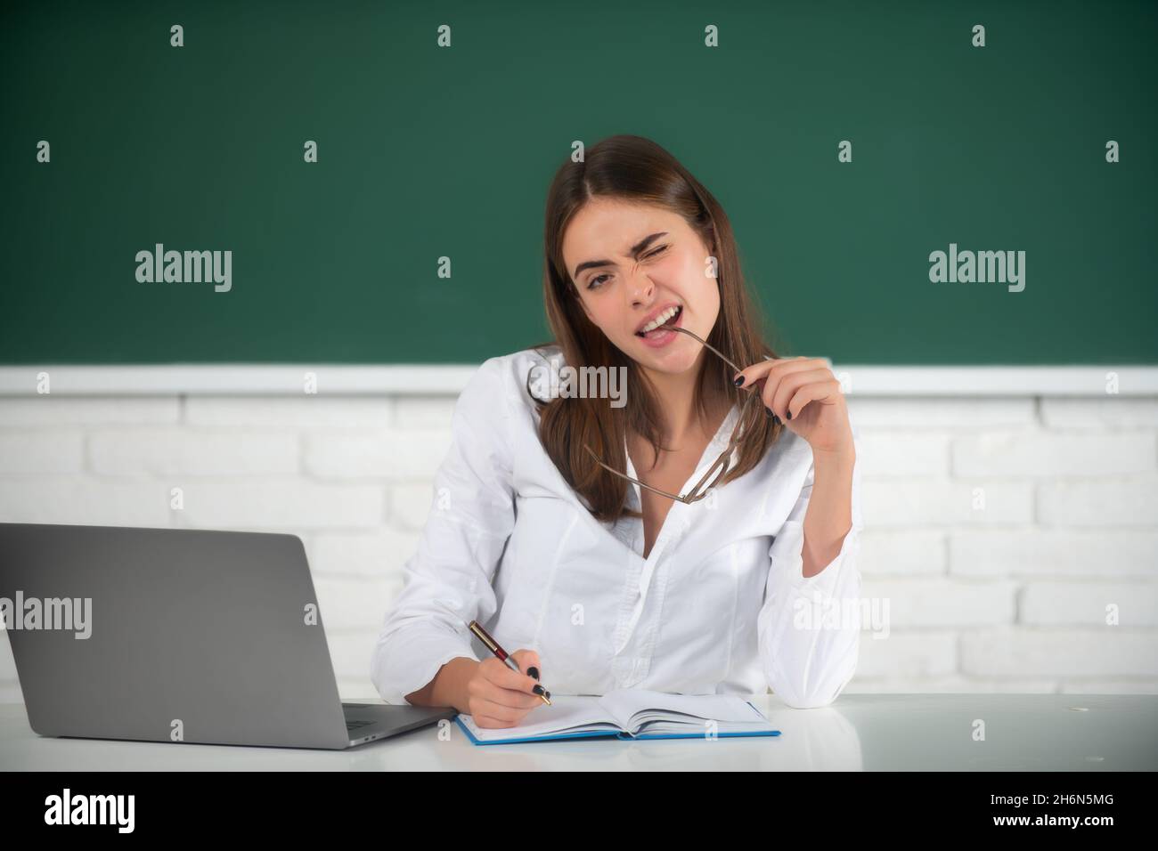 Portrait of a funny female student studying in school classroom. Female ...