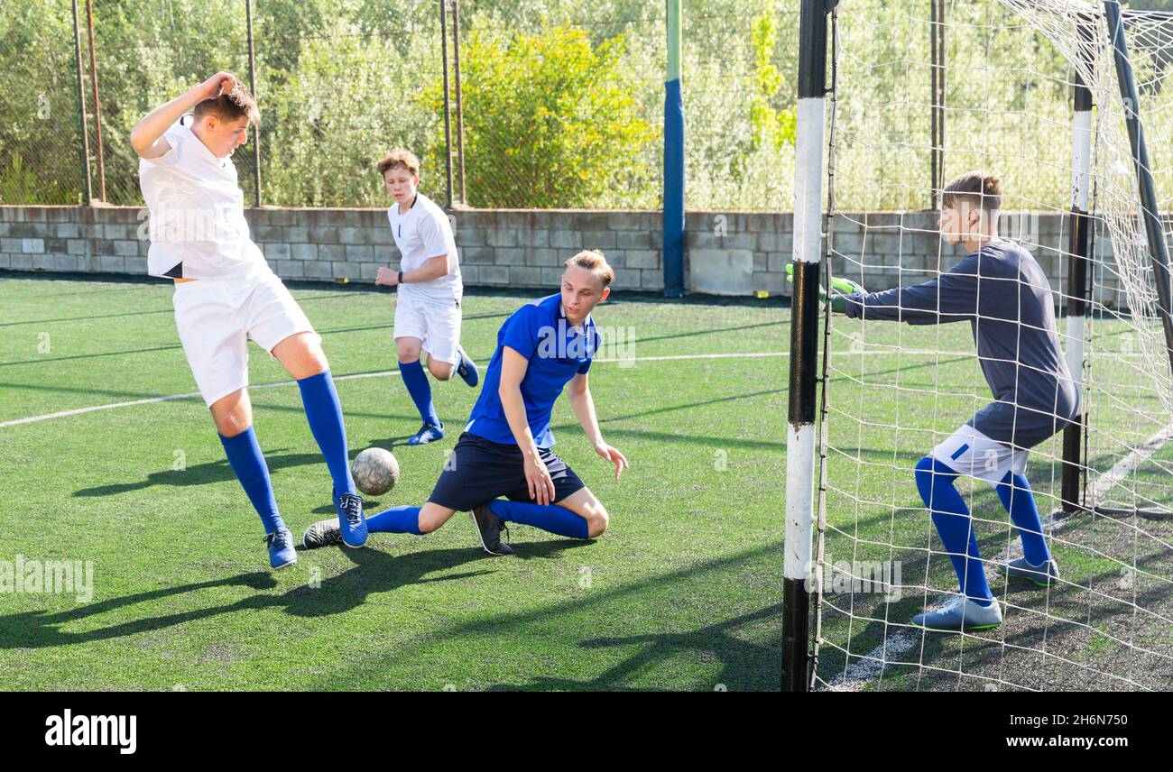 Defender tackles the ball in the penalty area Stock Photo - Alamy