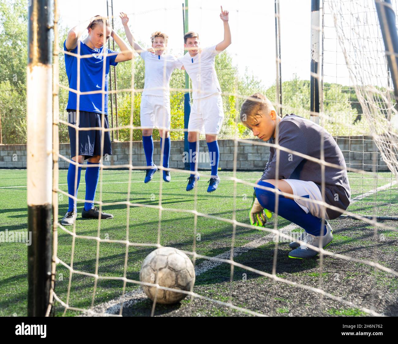Goalkipper feeling sad about he didn't catch ball Stock Photo - Alamy