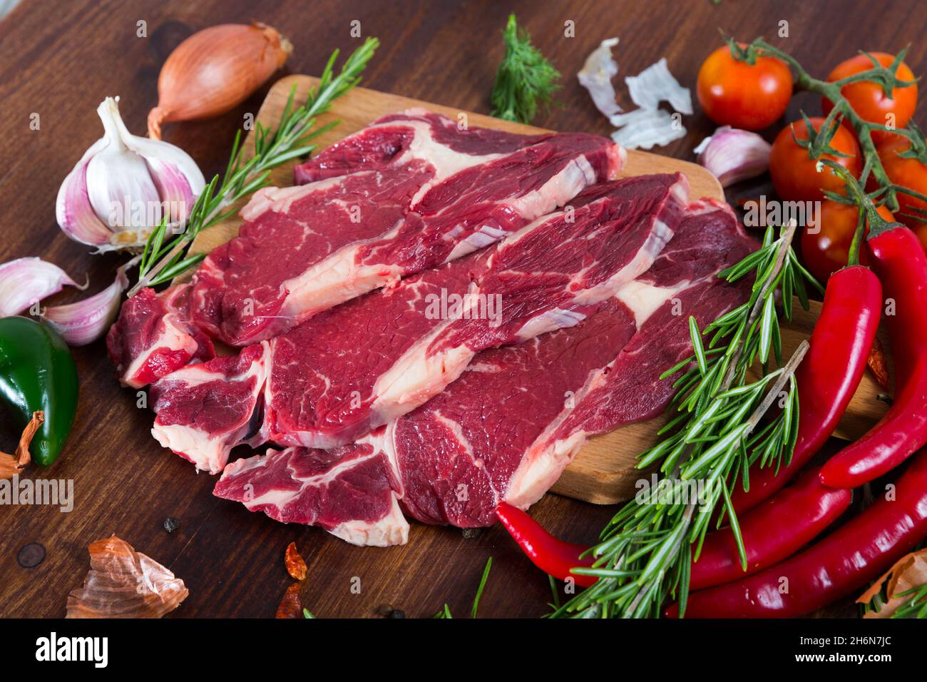 Raw beef meat on cutting board Stock Photo - Alamy
