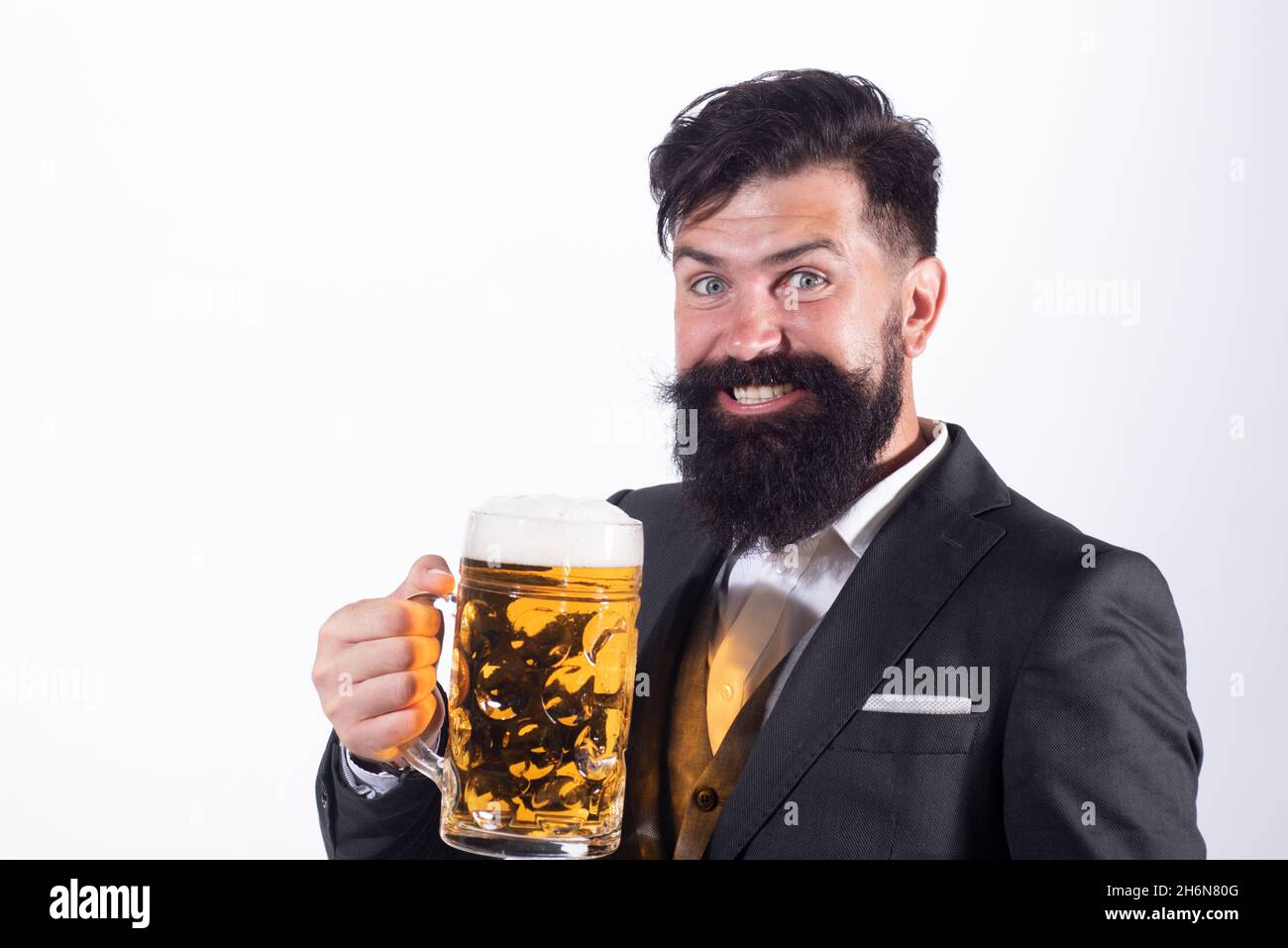 Happy man in classic suit drinking beer. Bearded guy in business outfit ...