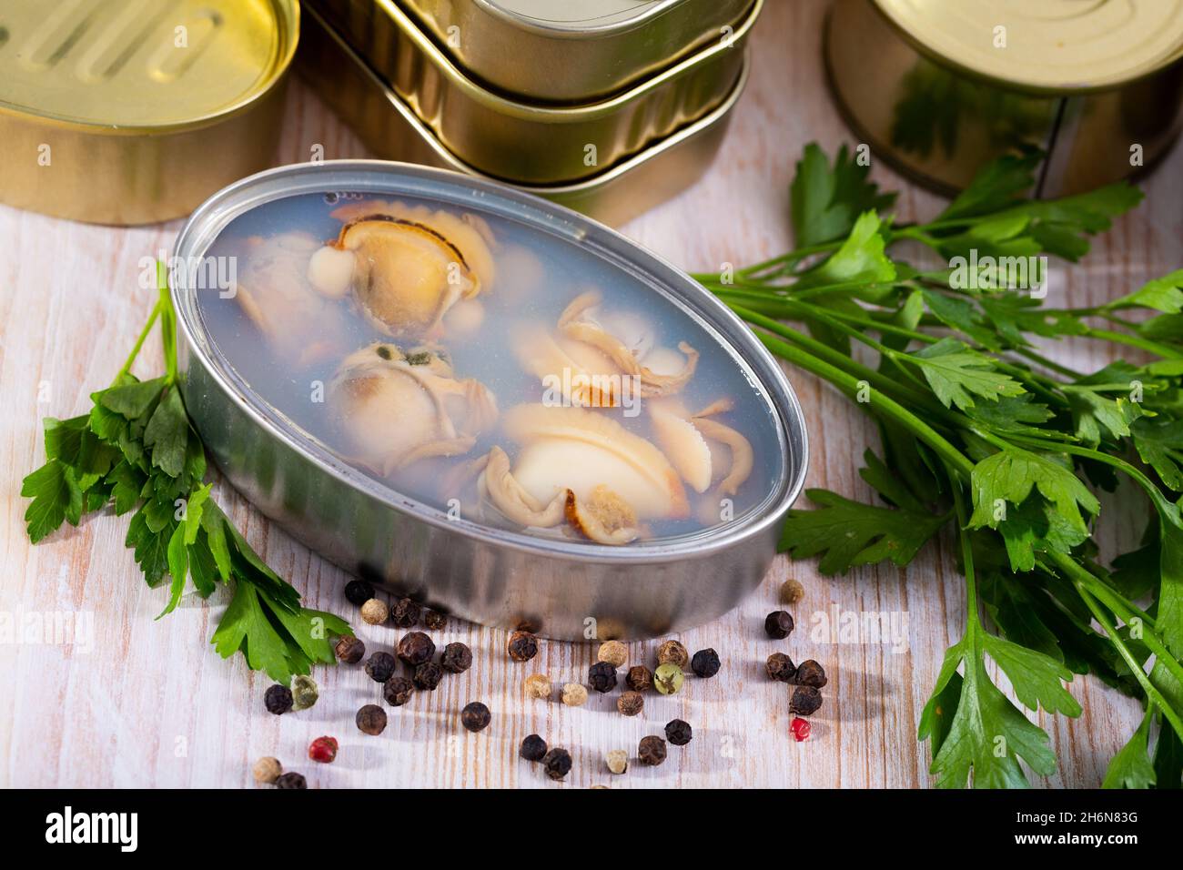 Tin can with sea shellfish in its own juice, closeup Stock Photo - Alamy