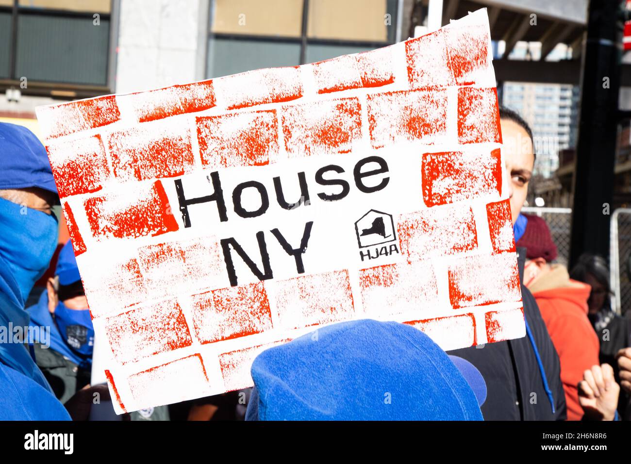 Demonstrator holds a sign saying, "House NY" during the protest.Housing ...