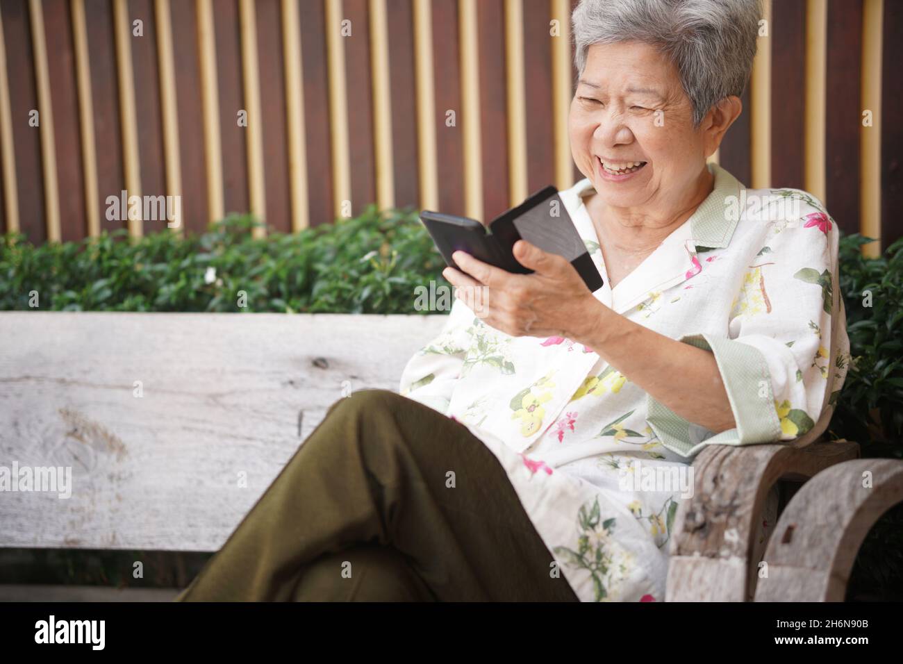 asian old asian elderly senior elder woman talking on smart mobile ...