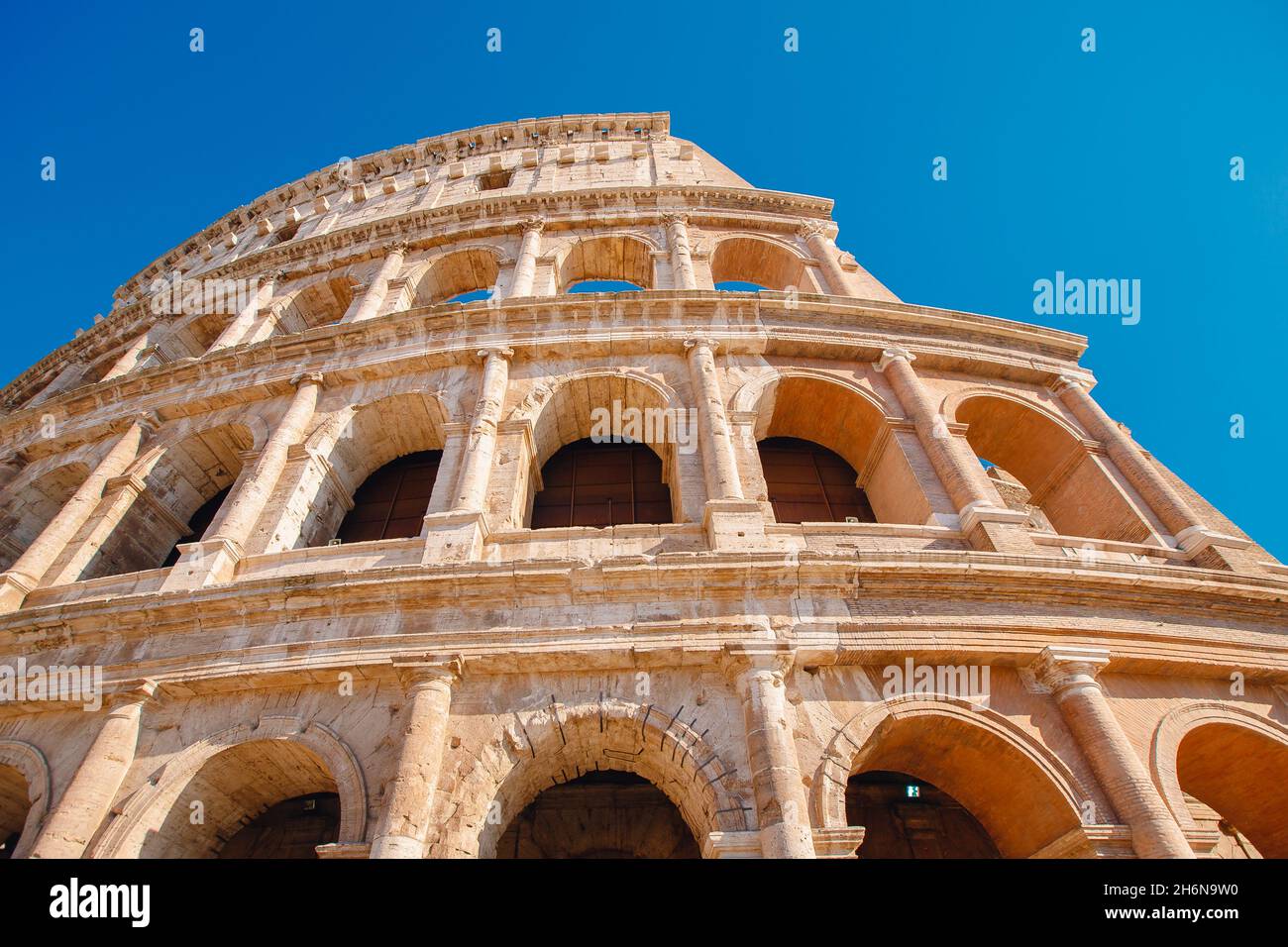 Colosseum or Coliseum ancient ruins background blue sky Rome, Italy ...
