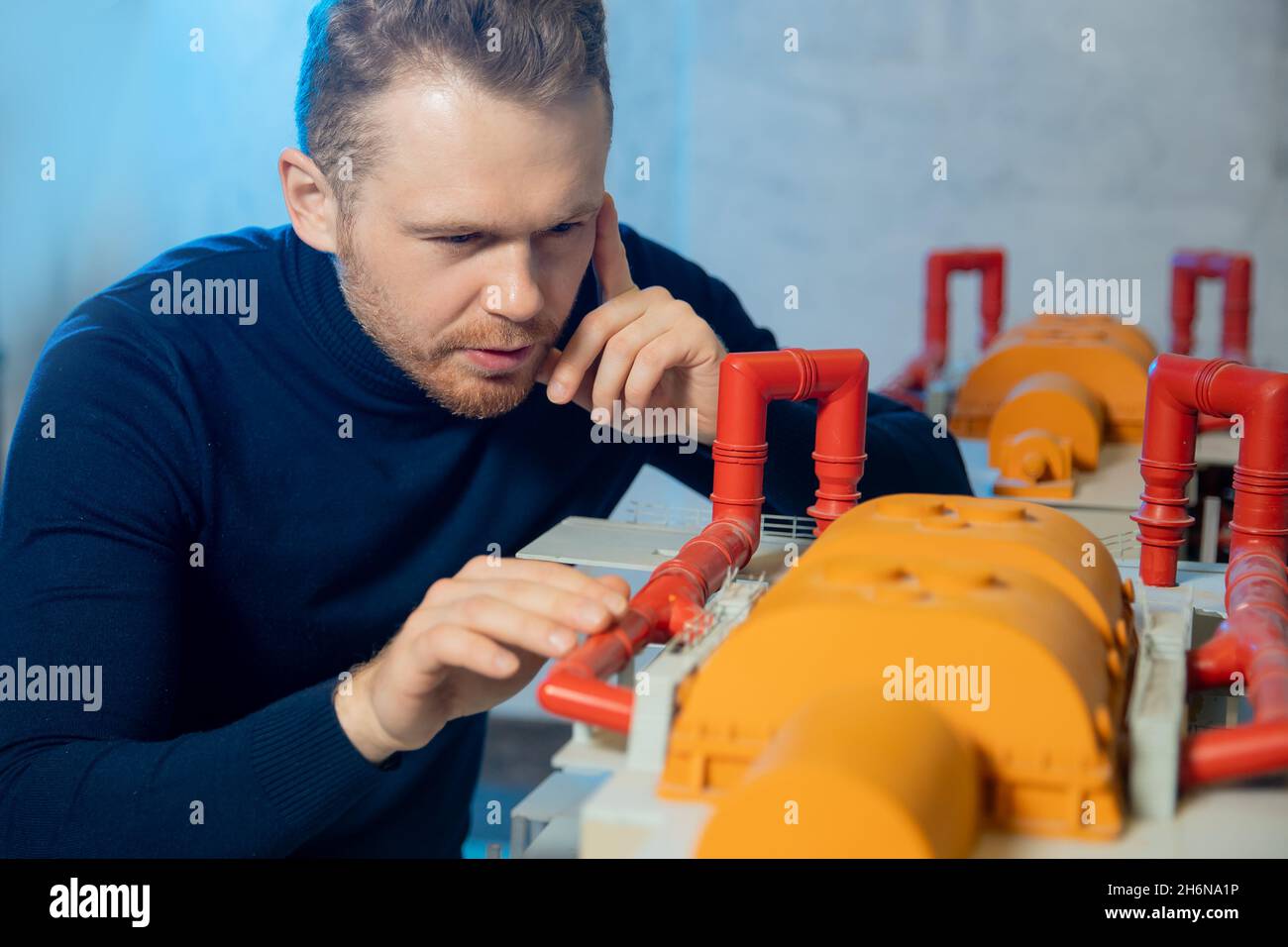 Young construction engineer man is studying layout of structure of ...