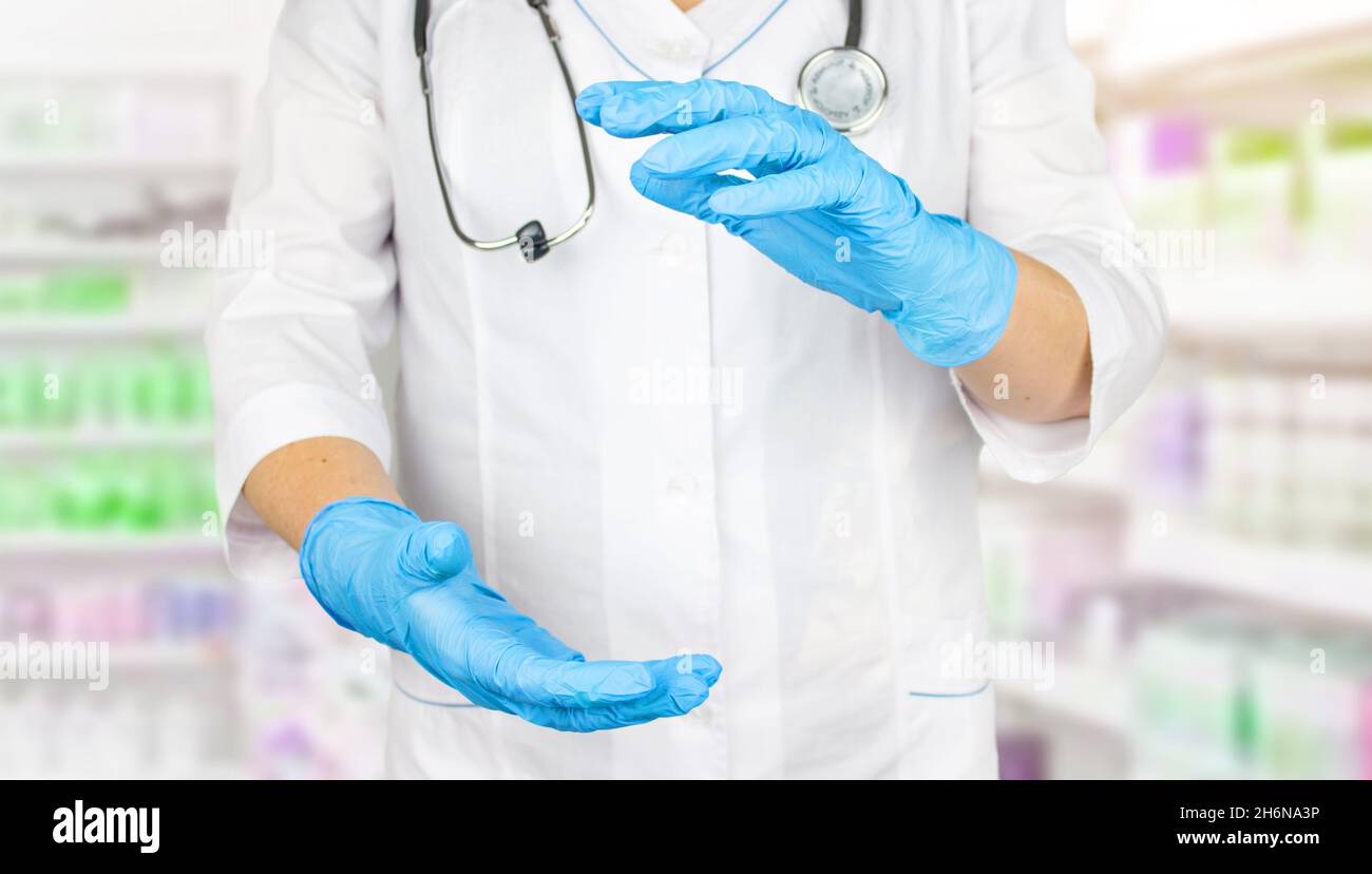 Female doctor showing something in her hand. Doctor empty palm in ...