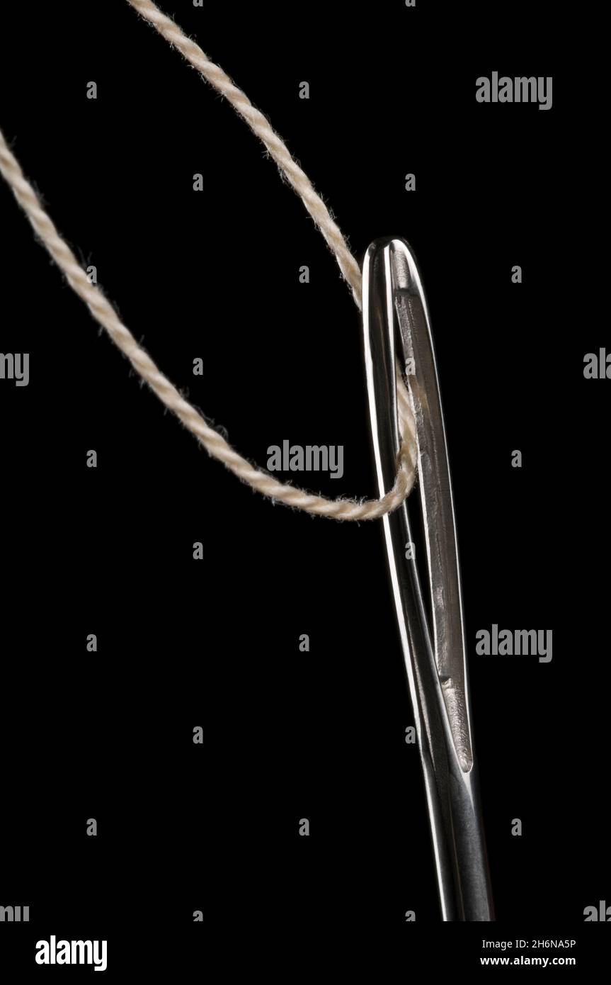 Sewing needle and thread, low key isolated Stock Photo - Alamy