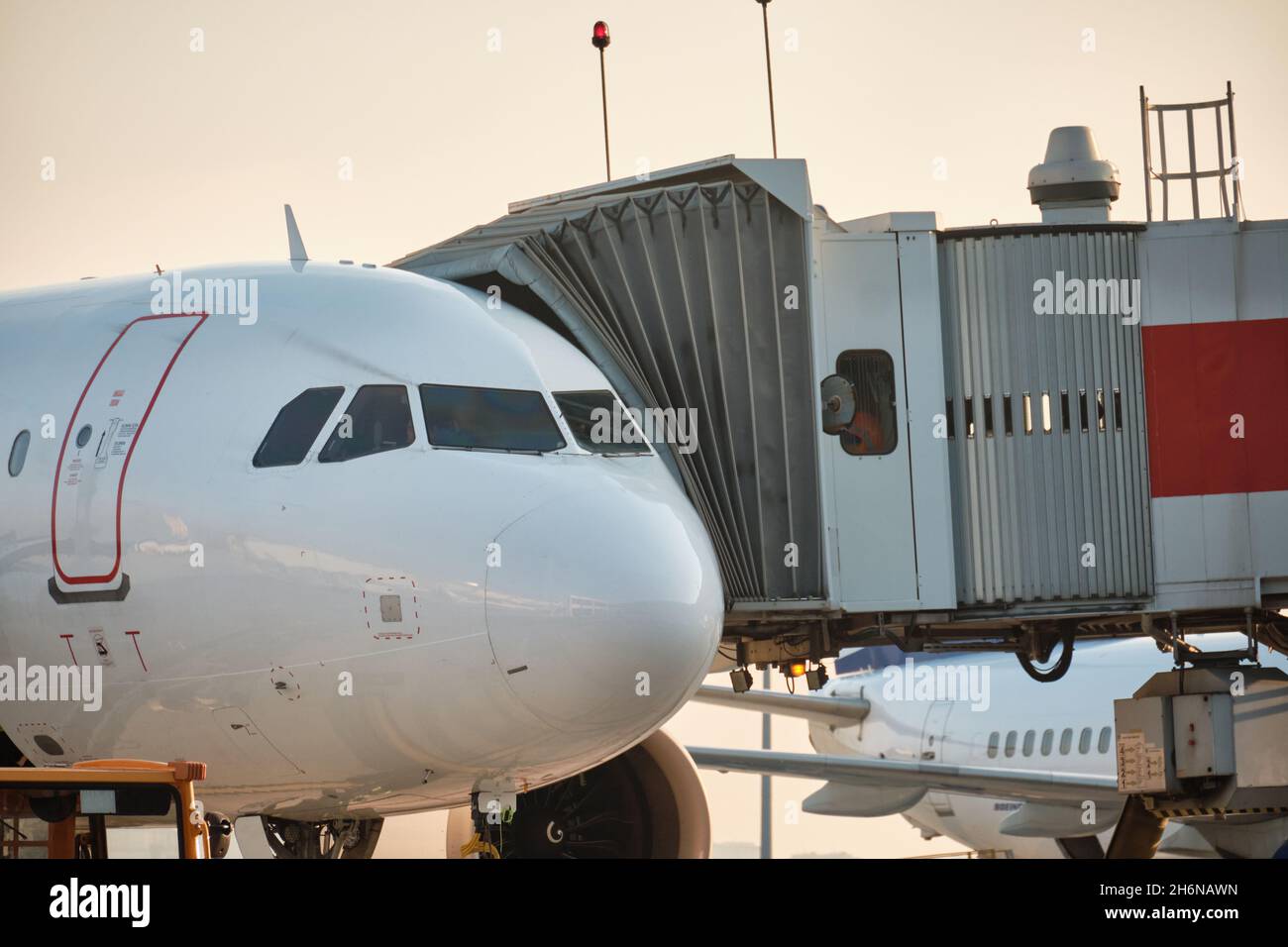 Plane with jetway in the evening Stock Photo - Alamy