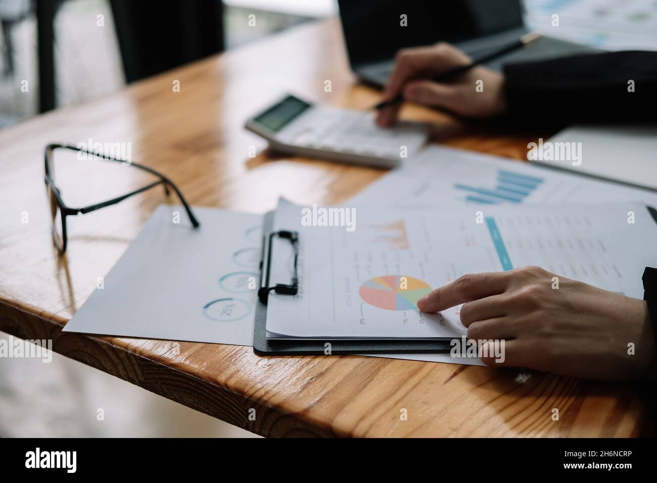Accountant working on desk using calculator for calculate finance ... Accountant working on desk using calculator for calculate finance ...