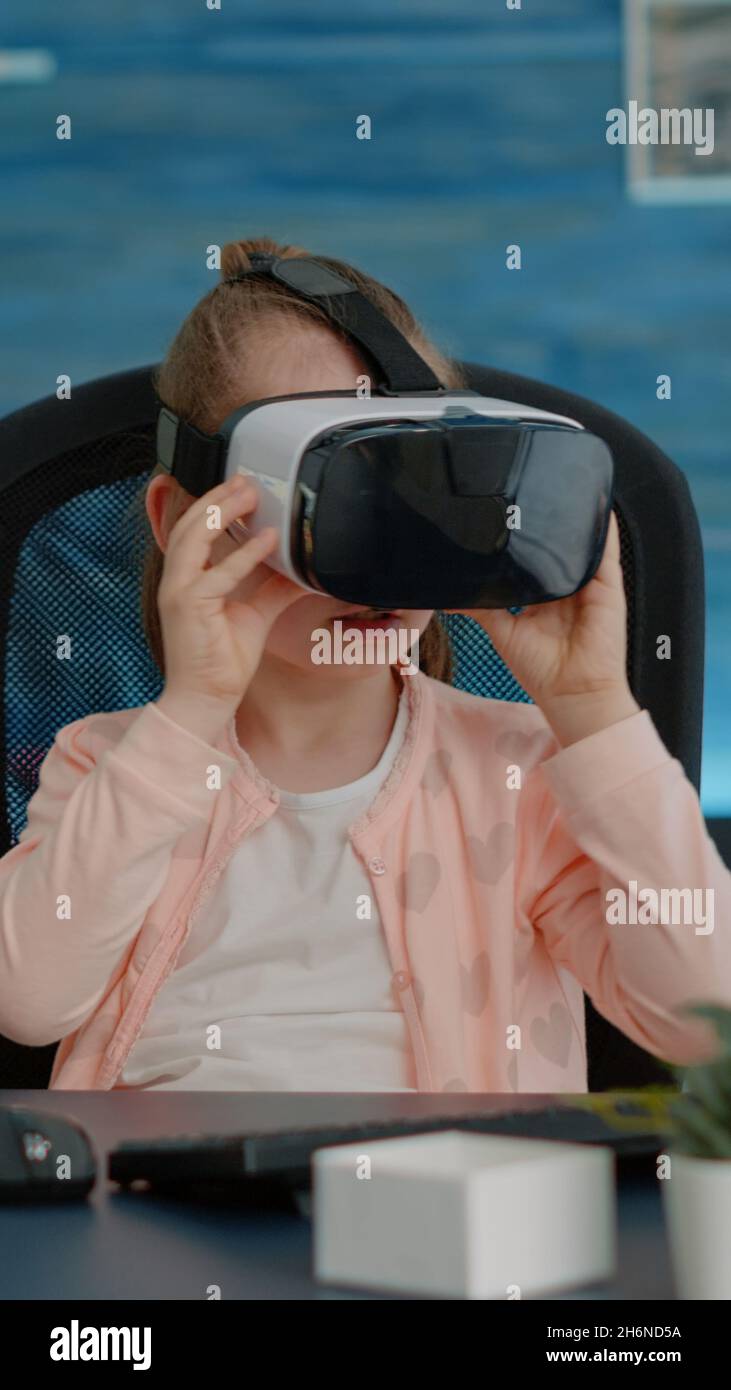 Young girl wearing vr glasses for virtual reality exercise at school ...