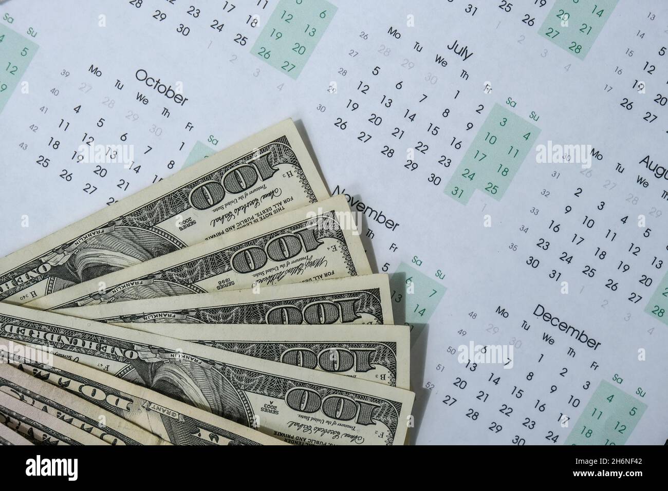 Office workplace desk with dollars and calendar. Counting money for ...