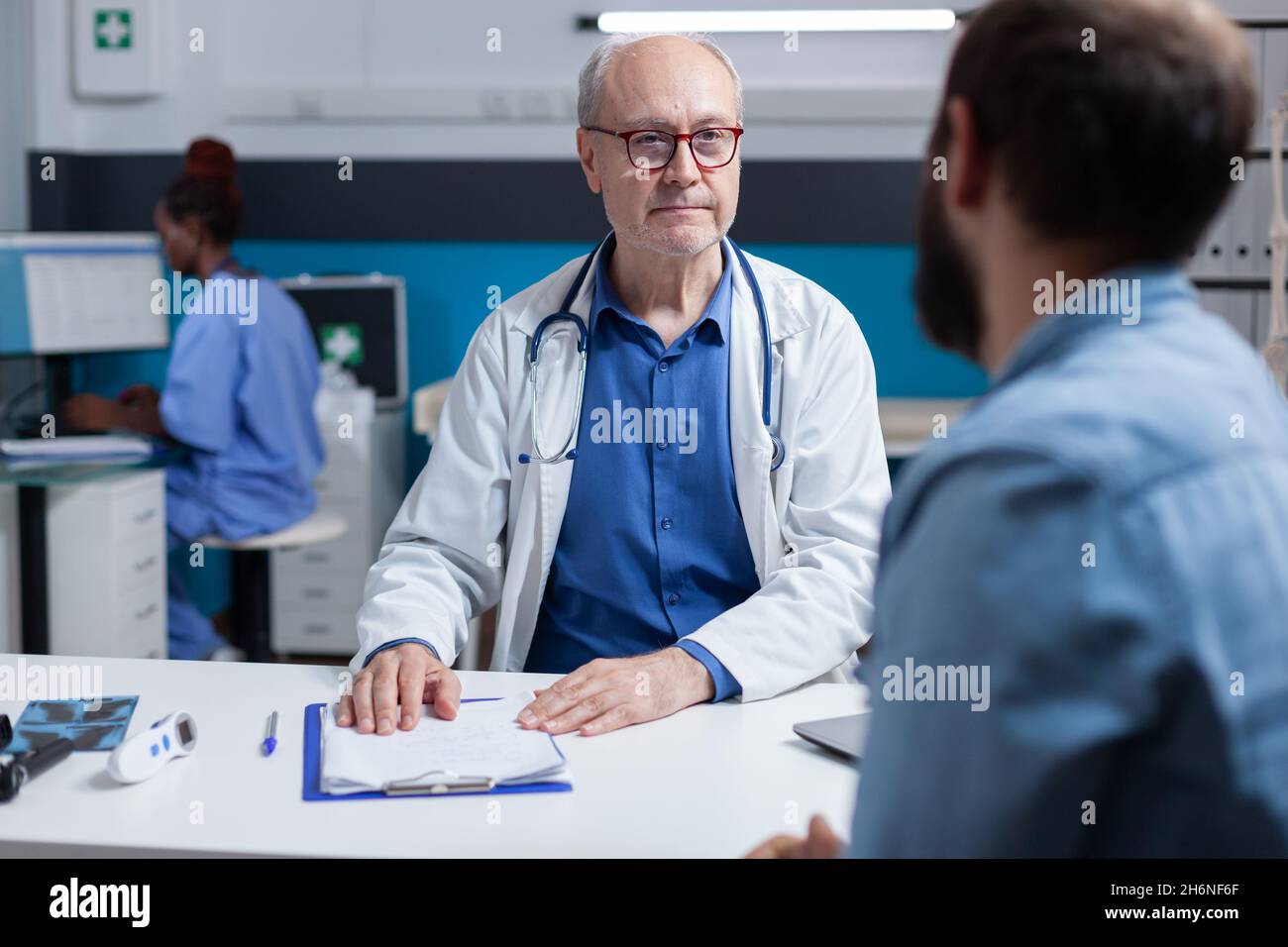 Doctor doing medical consultation with patient in cabinet. General ...