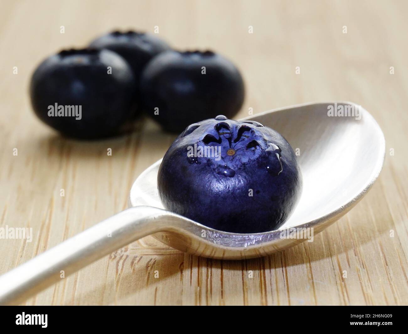 Fresh organic blueberry on a silver teaspoon. Healthy eating and ...
