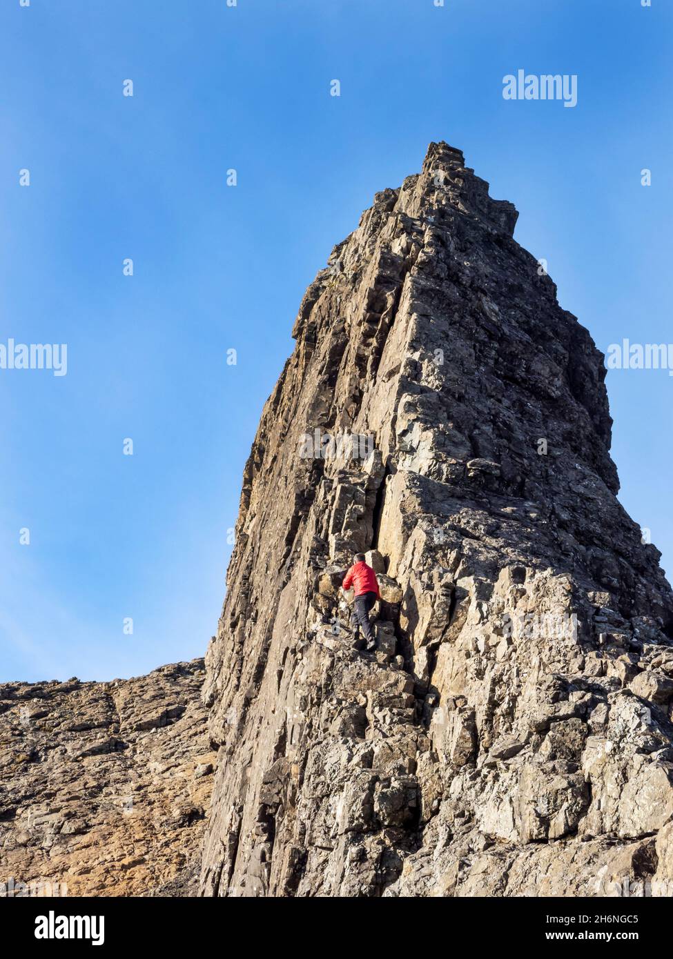 A climber soloing the Inaccessible Pinnacle on Sgurr Dearg on the ...