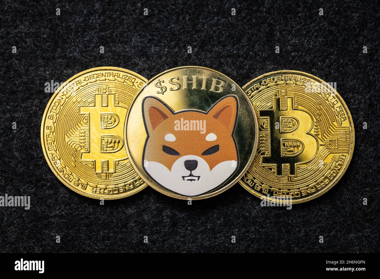 Shiba Inu Coin on top of Bitcoin physical coins Stock Photo - Alamy