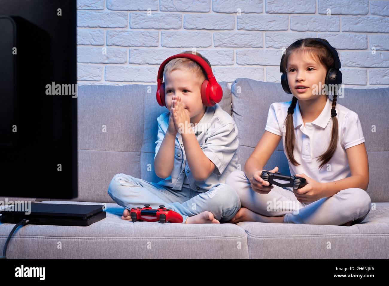 children playing video game with game console Stock Photo - Alamy