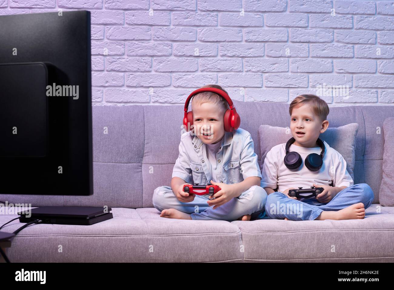 children playing video game with game console Stock Photo - Alamy