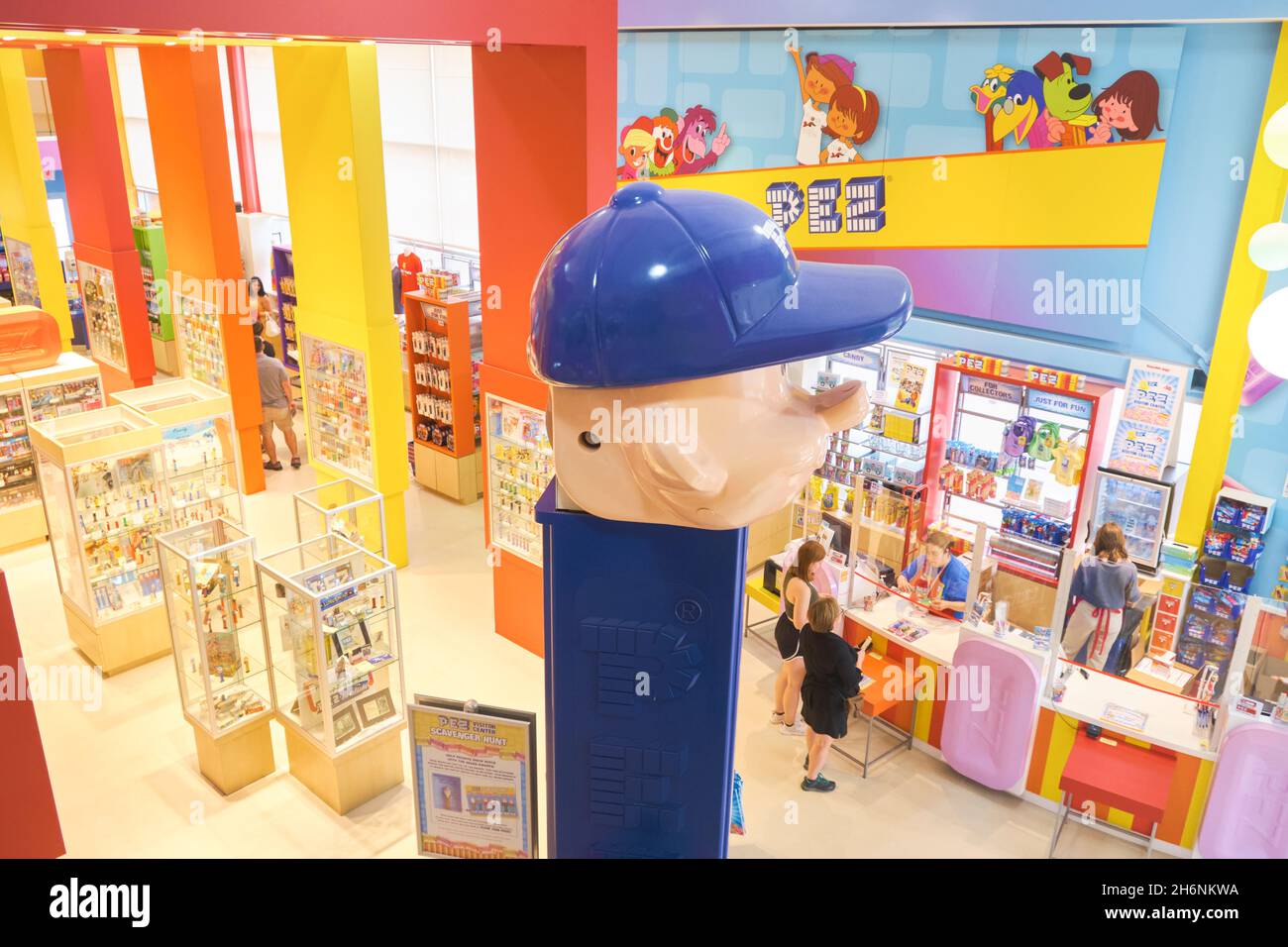 A huge model of a Pez dispenser, man wearing a blue baseball cap. At ...