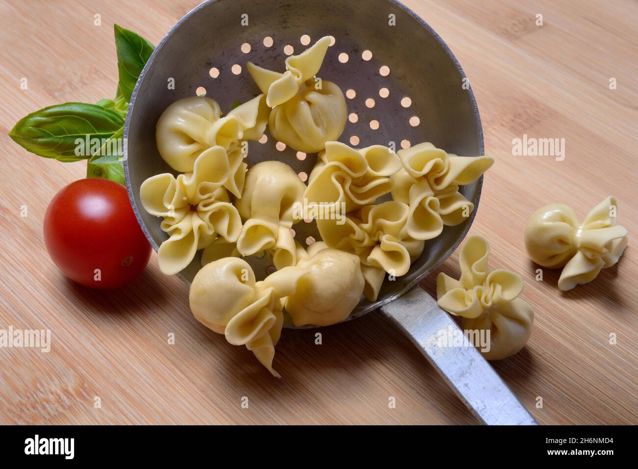 Saccottini, Italian pasta in a sieve ladle, pasta Stock Photo - Alamy