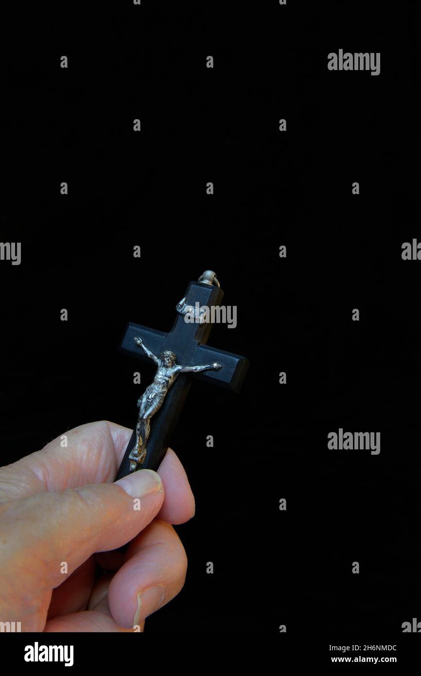 Hand holding crucifix, cross Stock Photo - Alamy