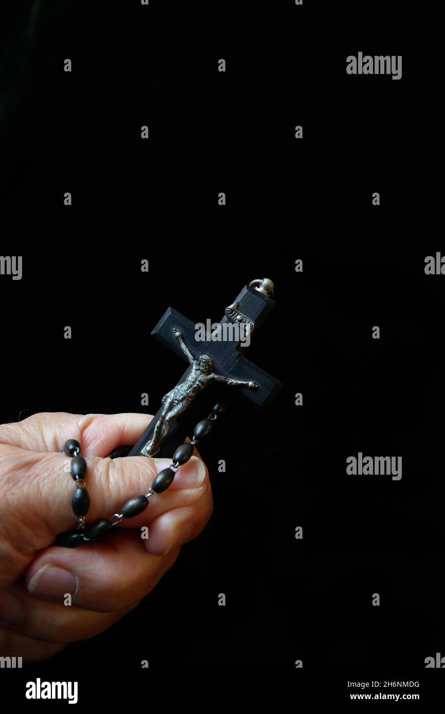 Hand holding crucifix, cross Stock Photo - Alamy