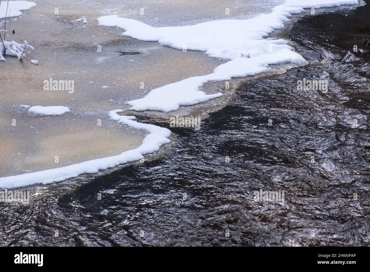 Ice edge by a river Stock Photo - Alamy