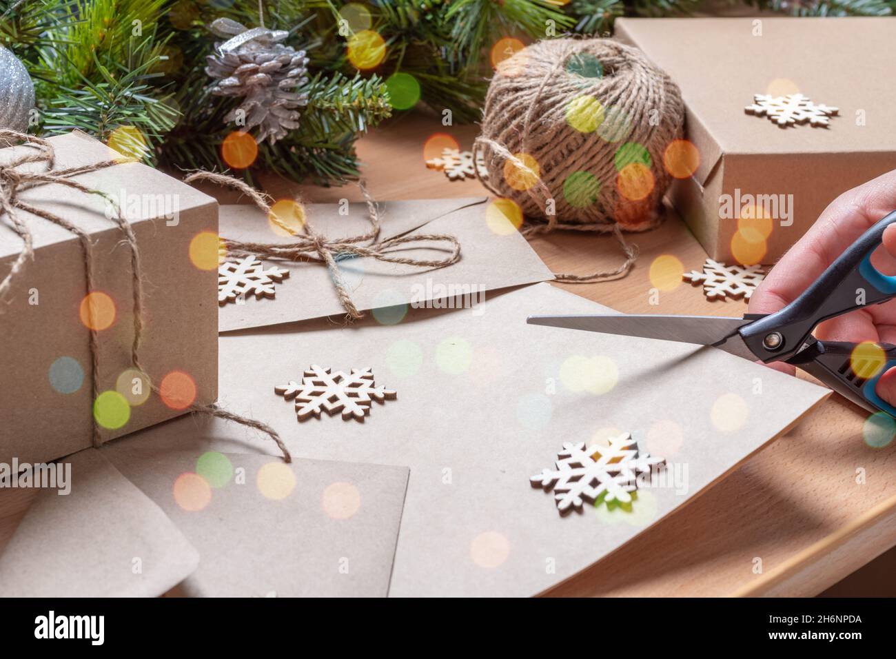 Packaging of ecological Christmas gifts - hand cutting recycled paper ...
