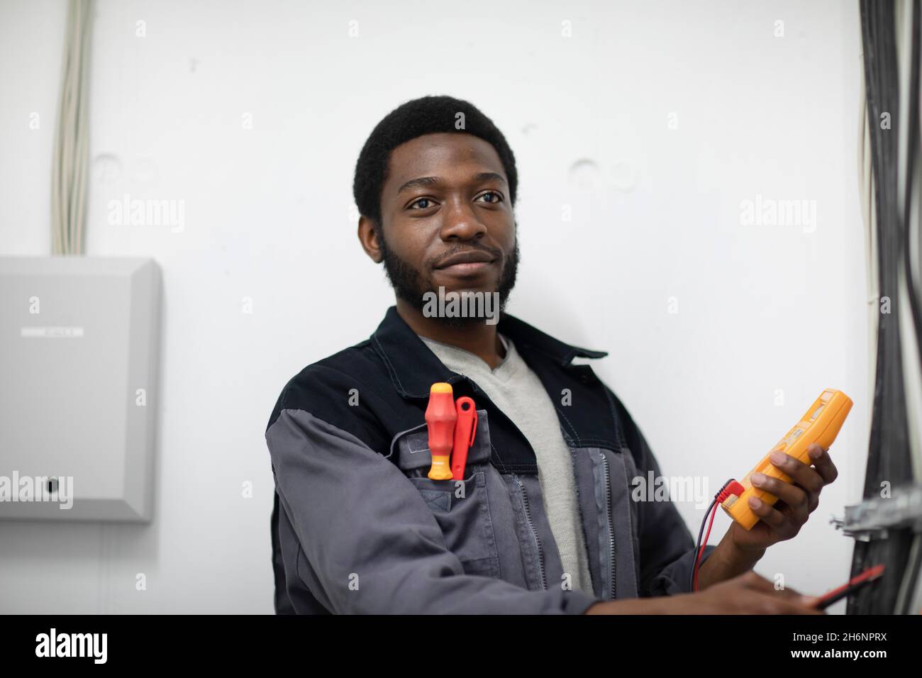 Young technician works in the building as a building technician in the ...