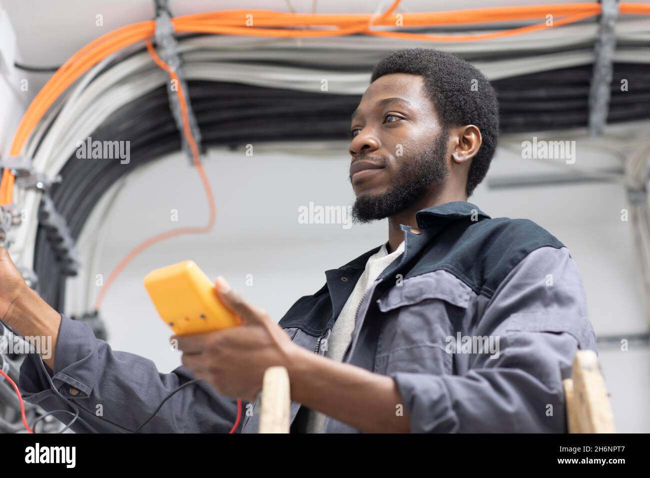Young technician works in the building as a building technician in the ...
