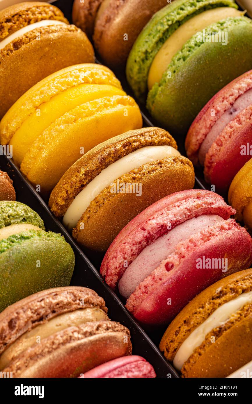 A row of bright macarons of different color. Close up of patisserie ...
