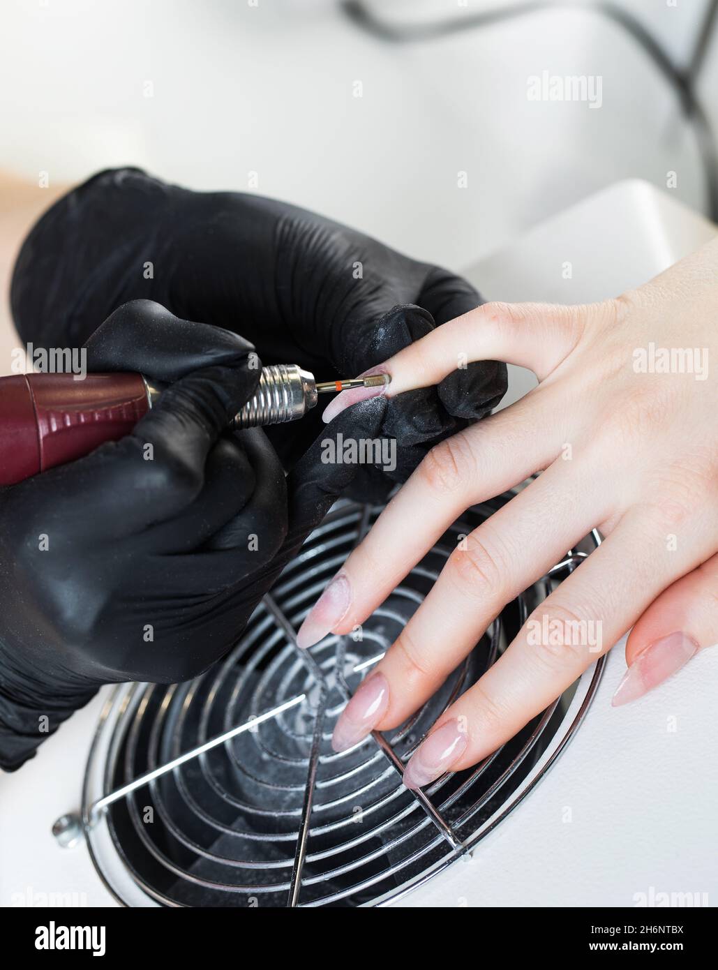 Hardware manicure. Manicure process, cuticle removal with a cutter ...