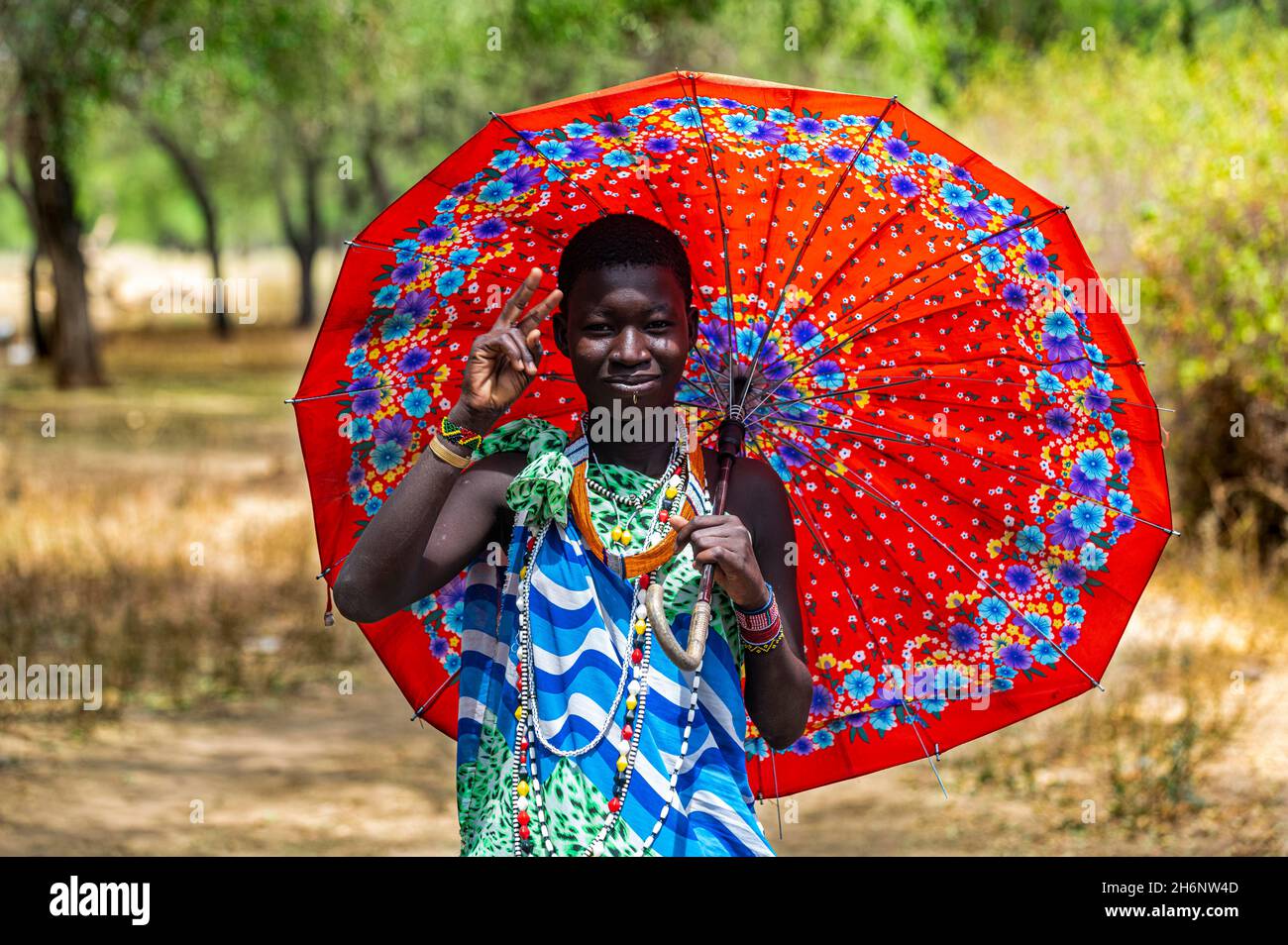 Girl carrying an umbrella, Toposa tribe, Eastern Equatoria, South Sudan ...
