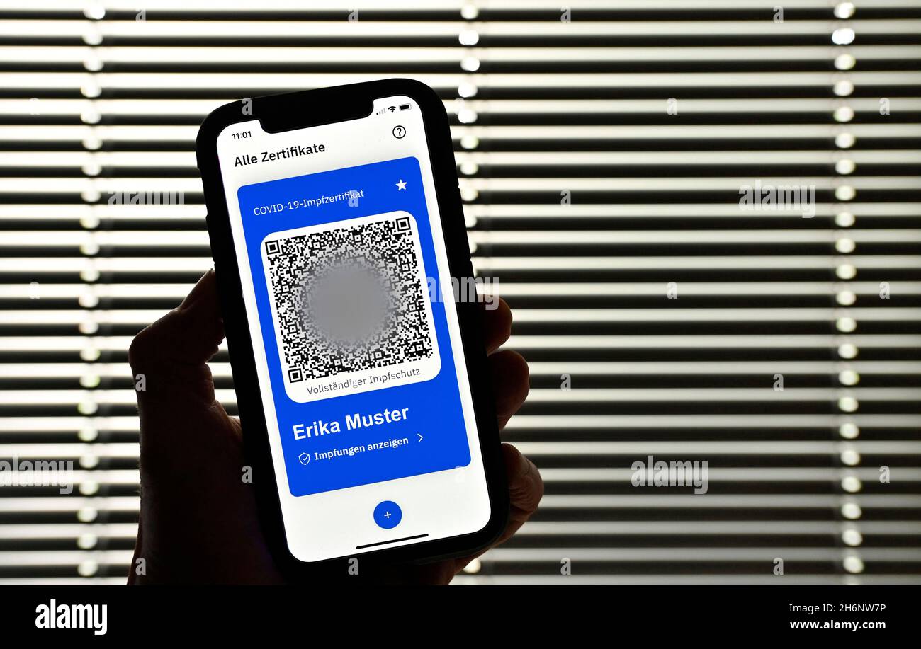 Symbol photo Vaccination privileges, hand holding app CovPass on ...