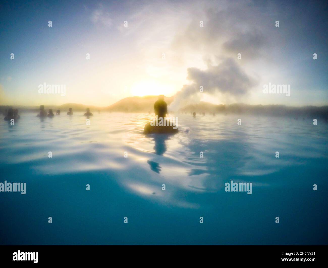 A bather enjoys The Blue Lagoon in Iceland. A natural geothermal pool ...