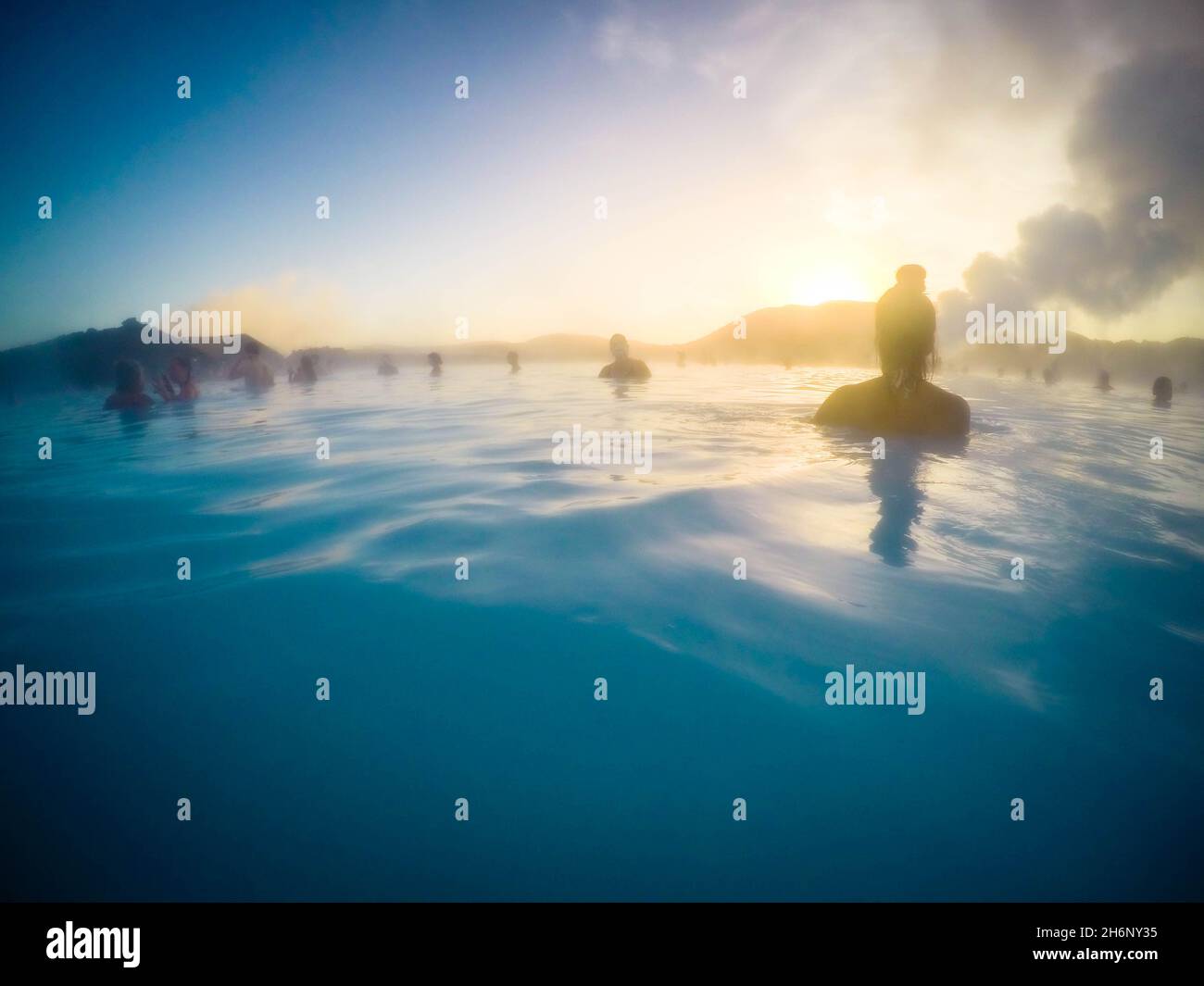 A bather enjoys The Blue Lagoon in Iceland. A natural geothermal pool ...