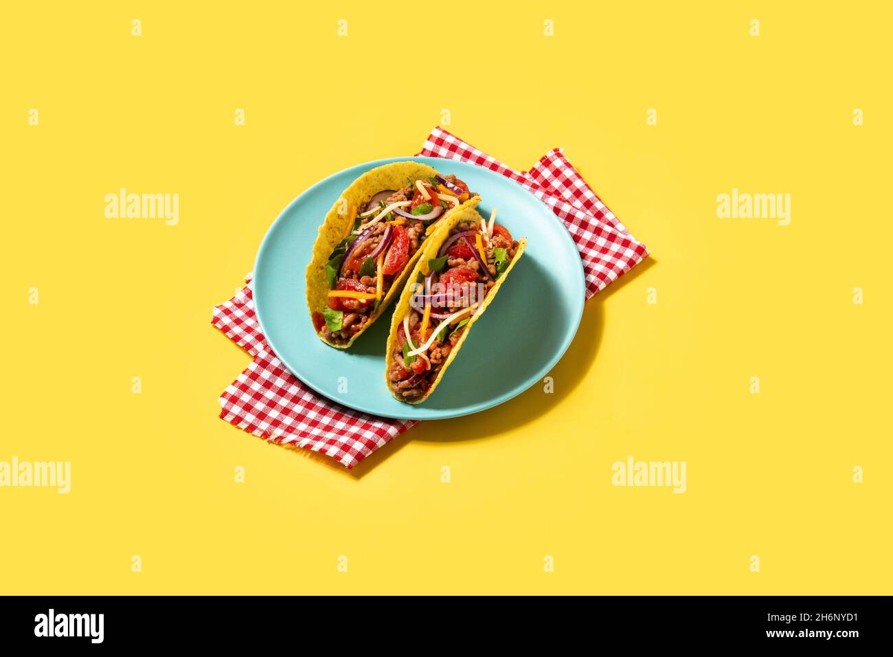 Traditional Mexican tacos with meat and vegetables on yellow background ...