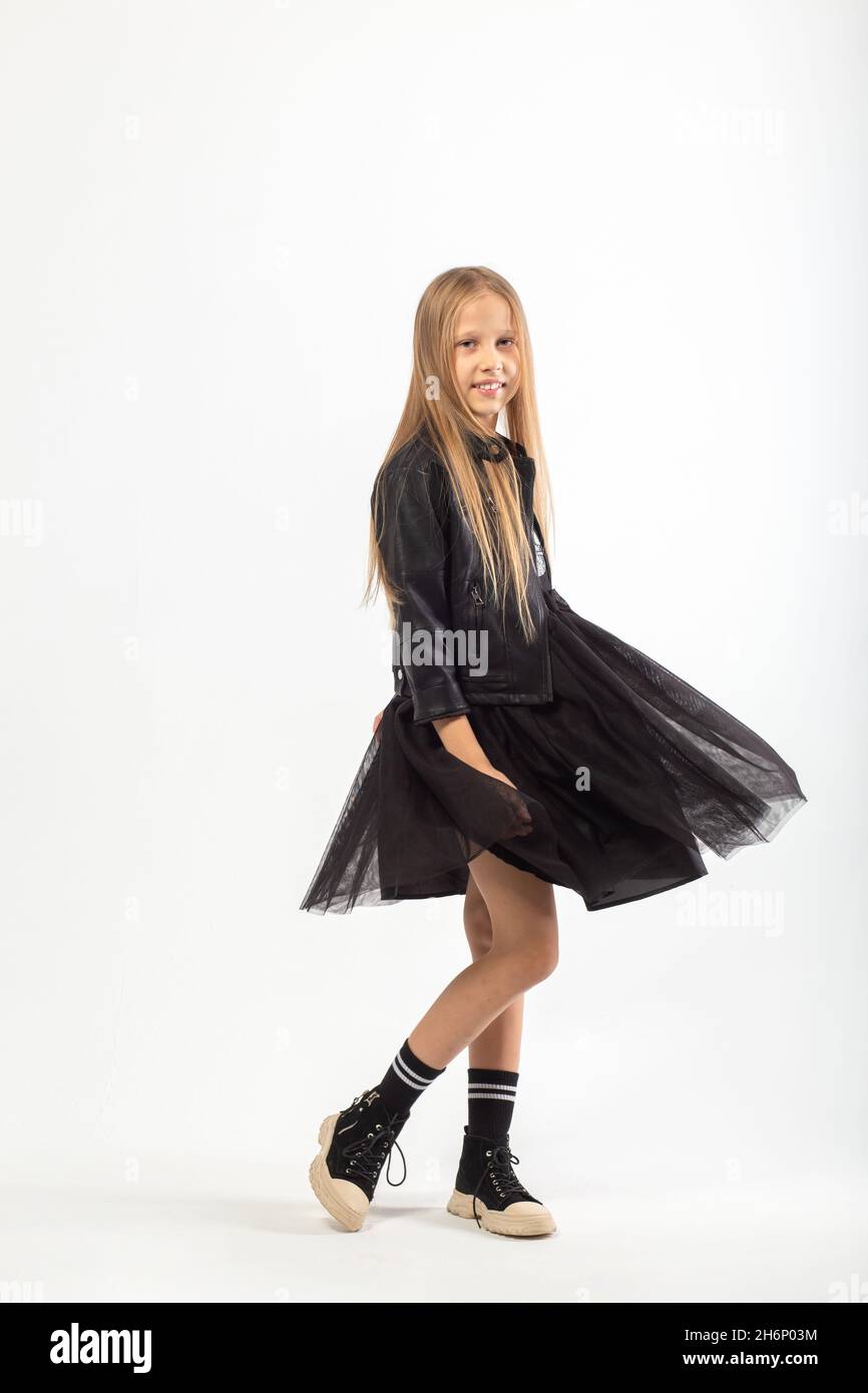 A full-length portrait of dancing young girl with long brown hair ...