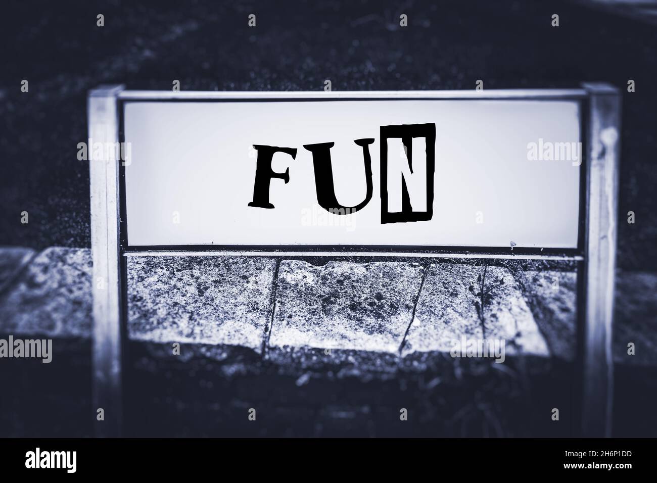 The word Fun displayed on a street road sign with black text on a white ...