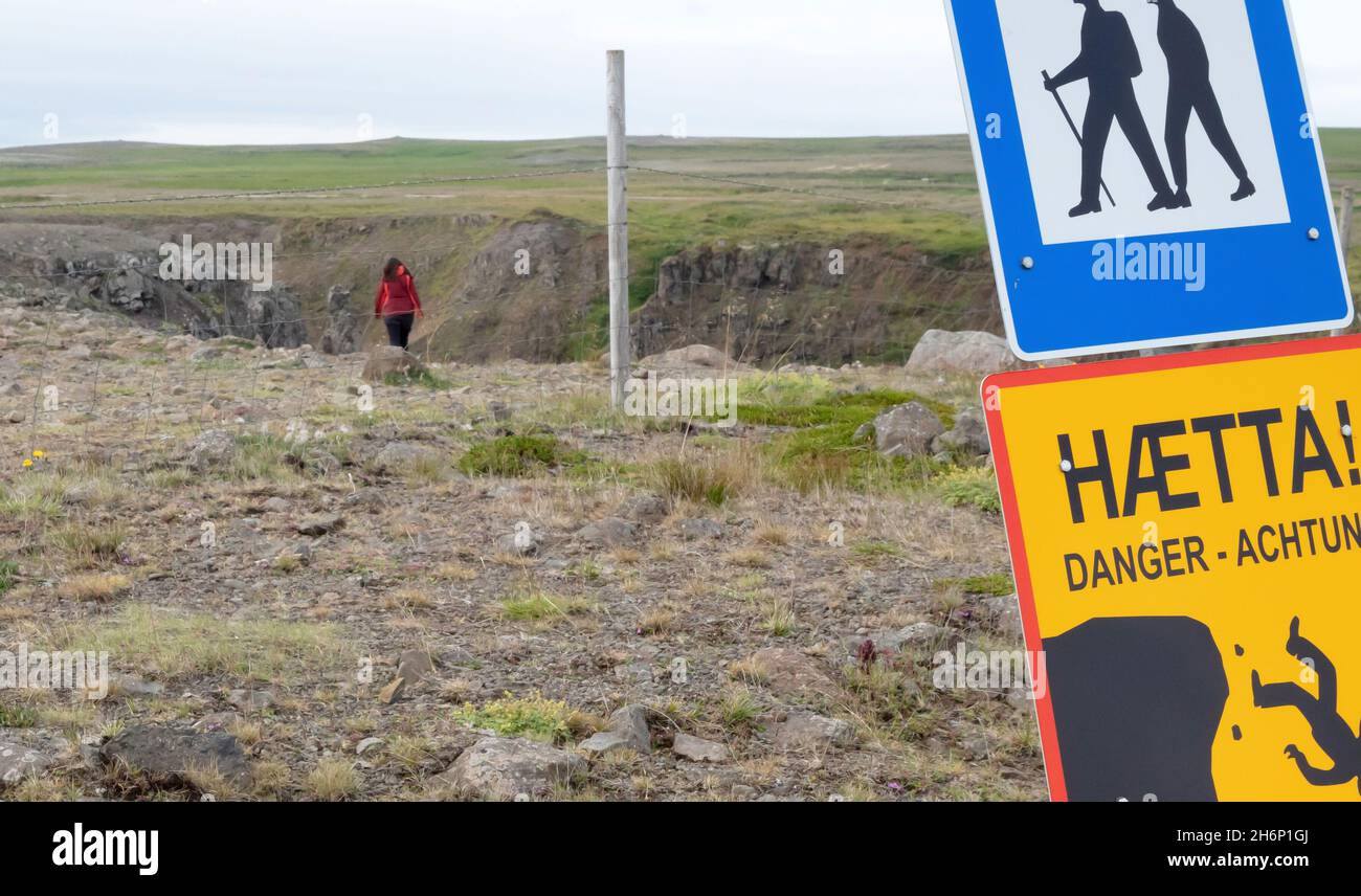 Yellow danger sign in Iceland - Warning of steep cliffs Stock Photo - Alamy